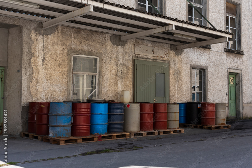 Facade of an old factory with empty oil metal drums fuel infront Stock ...