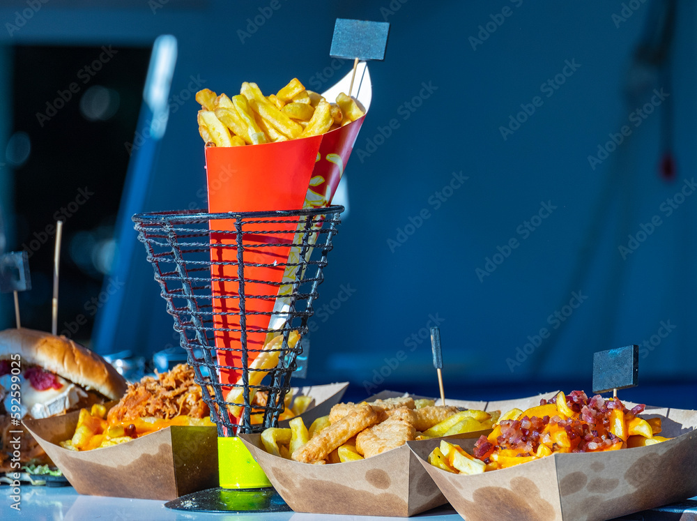 French fries cone and different types of fast food on the counter of a ...