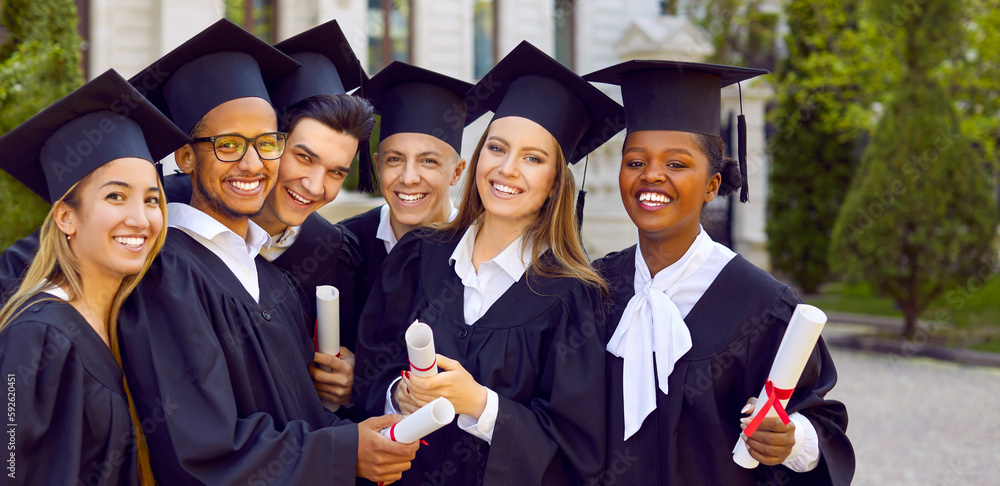 Outdoor portrait of happy diverse university graduates. Group of ...