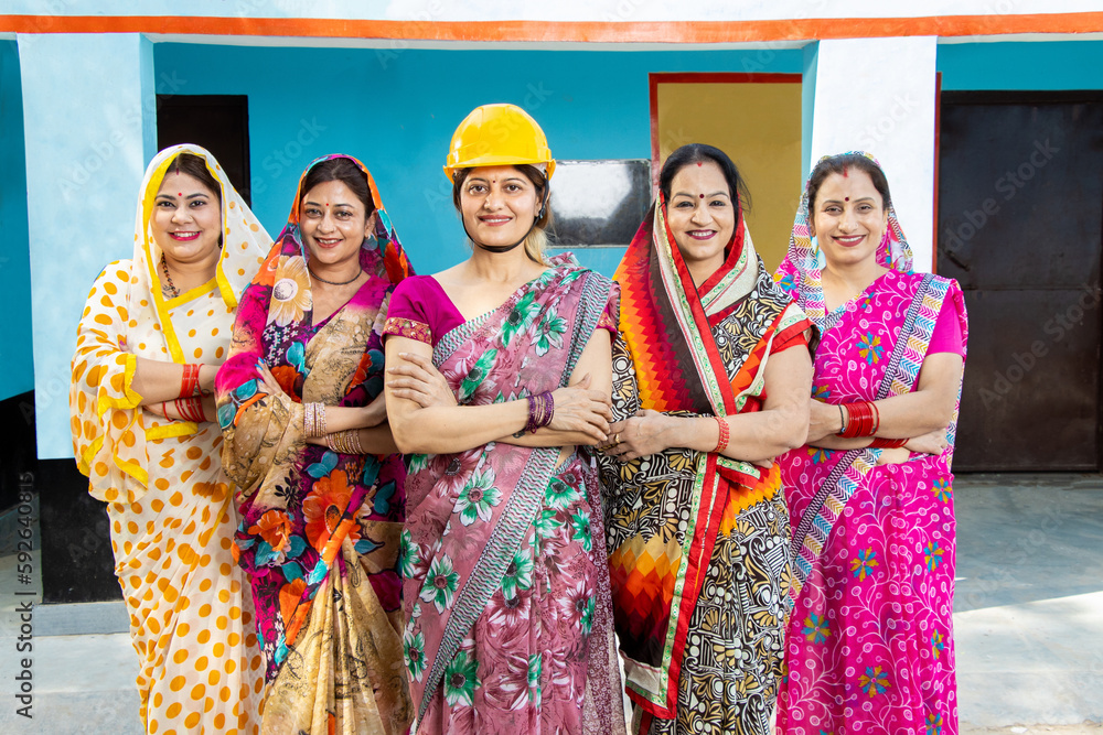 Group of confident young indian women housewives wear sari standing ...