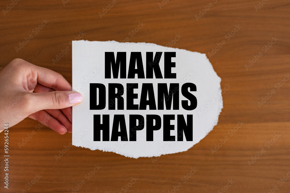 Foto de Make dreams happen. Woman hand holds a piece of paper with a ...