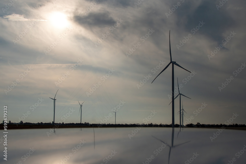 Wind farm with tall turbines tower producing renewable source of energy ...