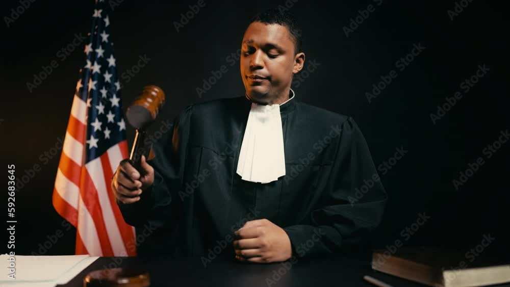 Serious judge addressing the courtroom, announcing verdict, US law ...