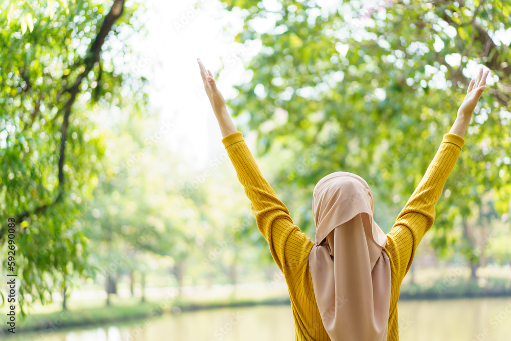 Happy cheerful Asian beautiful female muslim practicing an exercise and ...