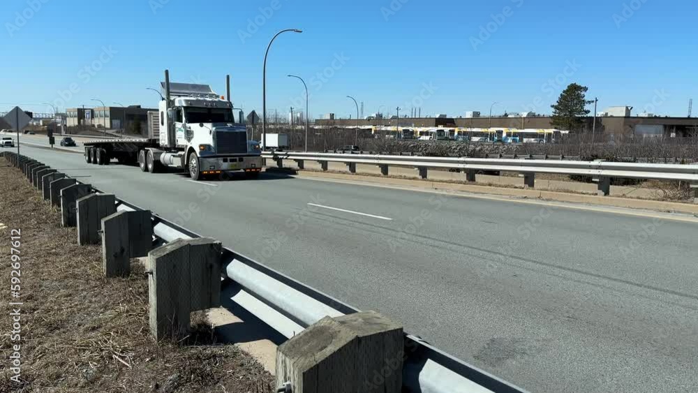 White semi trailer with an empty cargo trailer on a busy highway at the ...