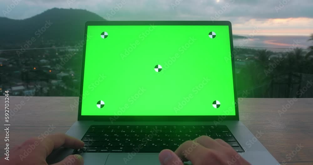 Male businessman using computer with green screen while sitting on ...