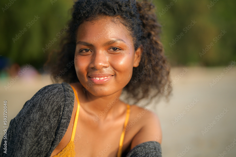 African woman sitting on bench beach at tropical beach. Young traveler ...