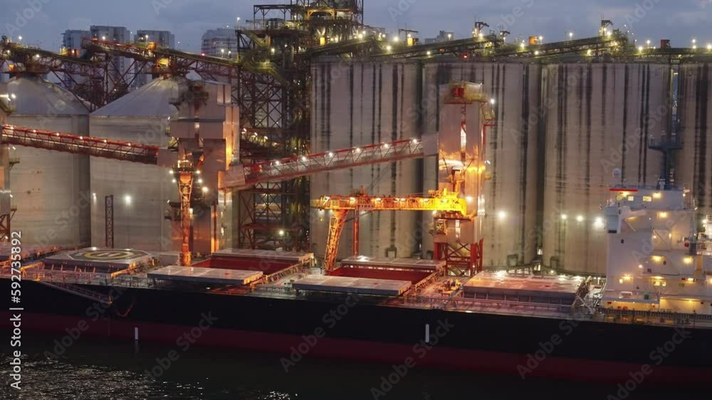 Loading grain into holds of sea cargo vessel through an automatic line ...