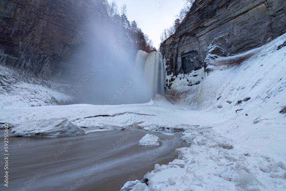 Cold mist rises from the frozen Taughannock Falls in the winter ...