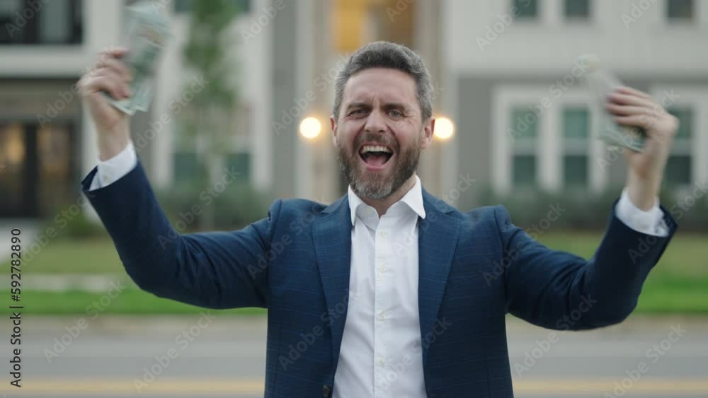 Excited man with money cash outdoor. Dollar banknotes. Portrait of man ...