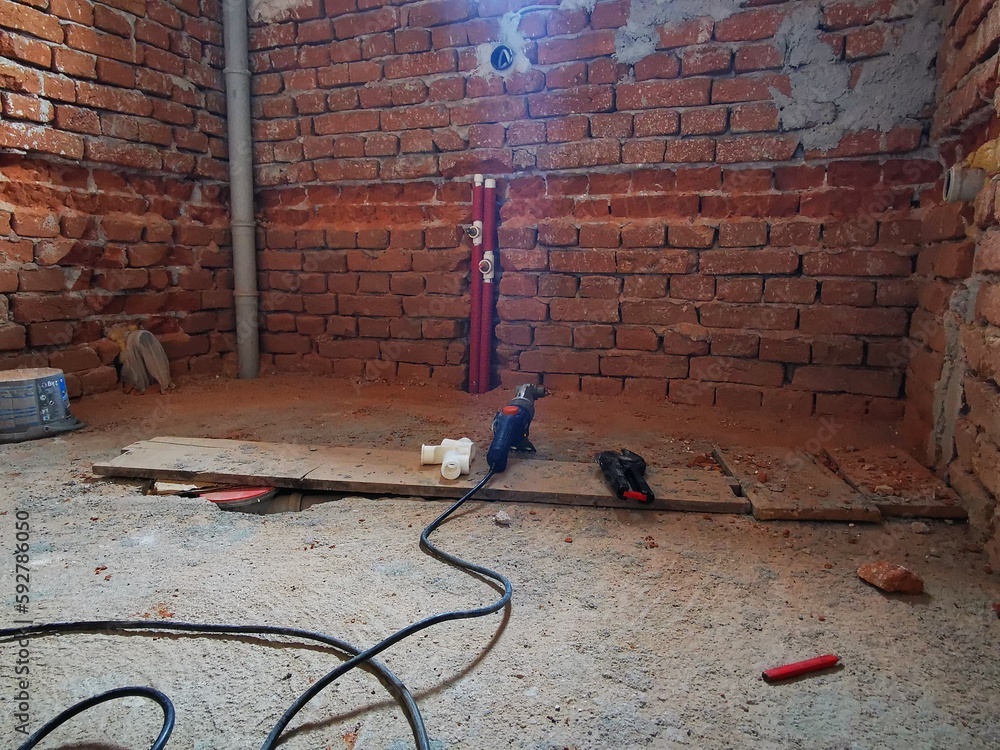 Plumber work. bathroom renovation - removing tiles in old apartment ...