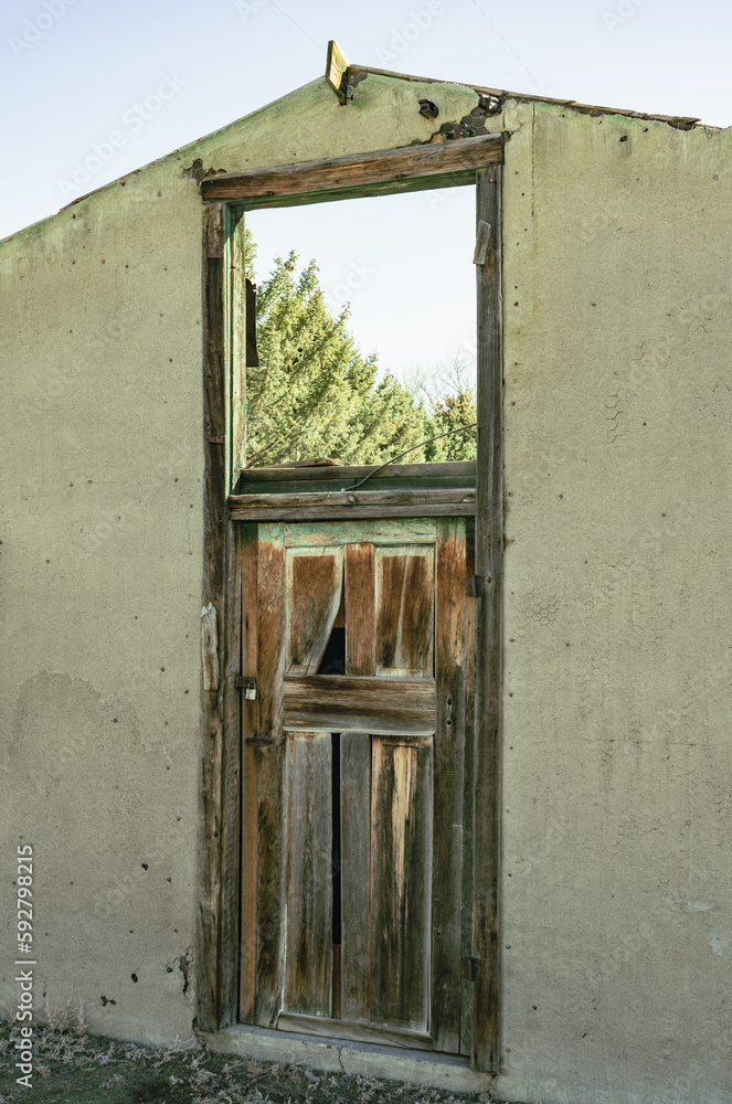 Old abandoned building is missing a roof, a top window, and other walls ...