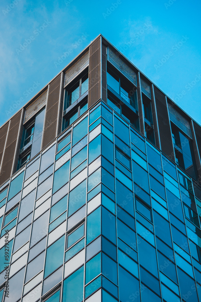Tower block office building windows reflective glass blue sky tall ...