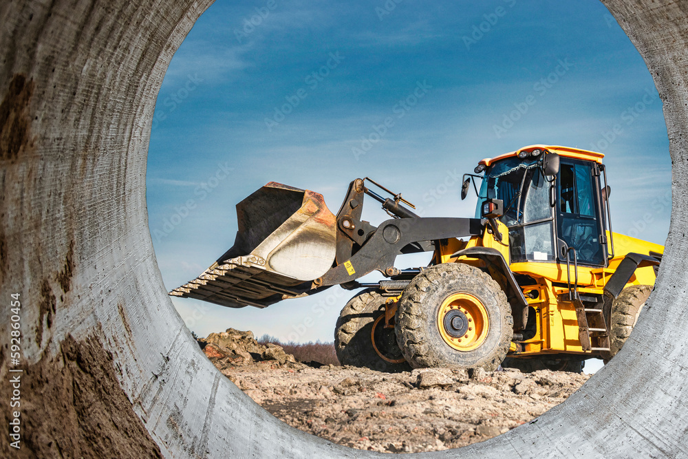 Powerful wheel loader or bulldozer working on a quarry or construction ...