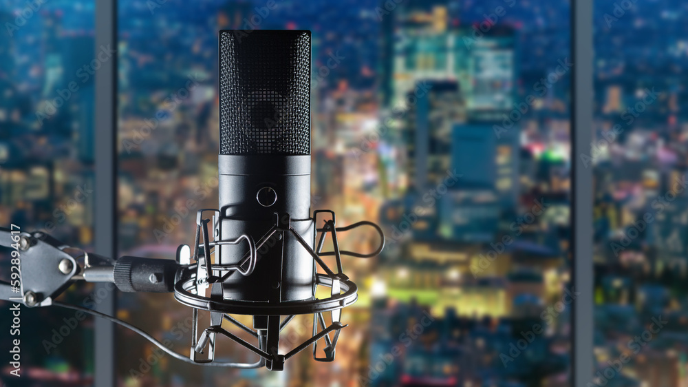 Condenser microphone. Recording micro. Night city behind microphone ...