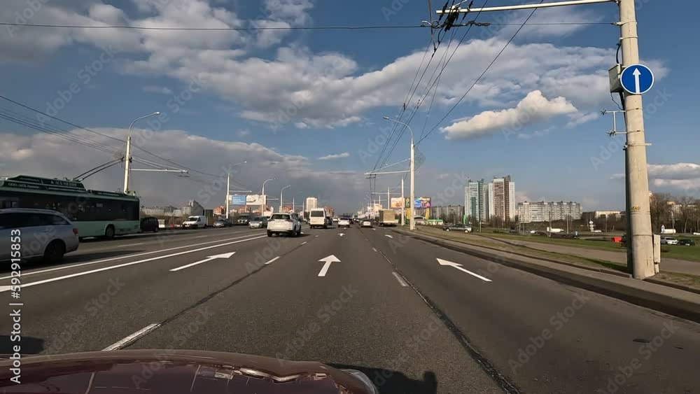 The car drives along the road in the city street on a summer day ...