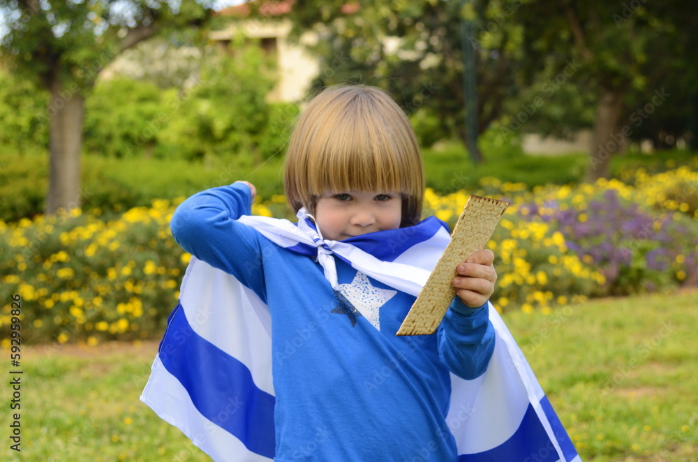 Little boy with the flag of Israel. A child in a blooming garden ...