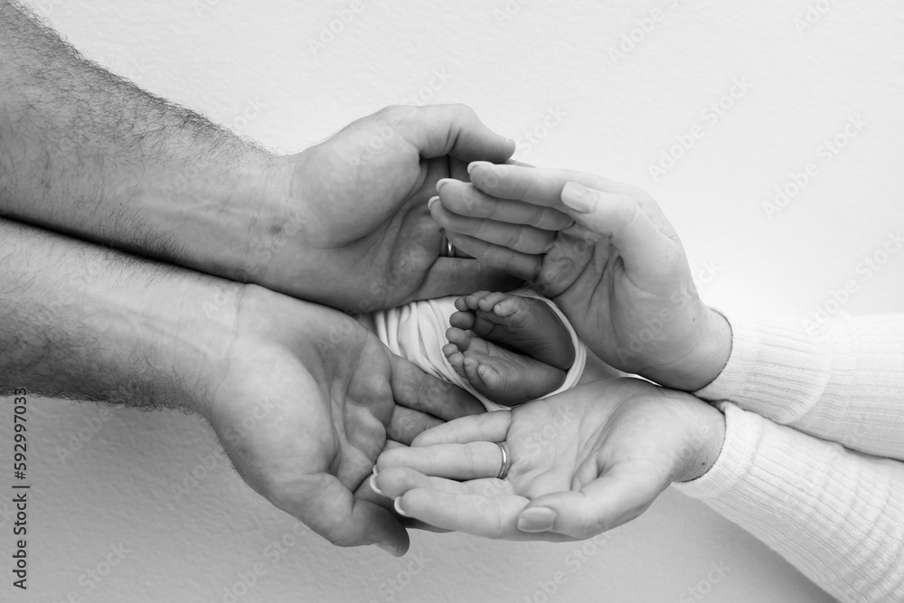 Children's leg in the hands of mother, father, parents. Feet of a tiny ... Children's leg in the hands of mother, father, parents. Feet of a tiny ...