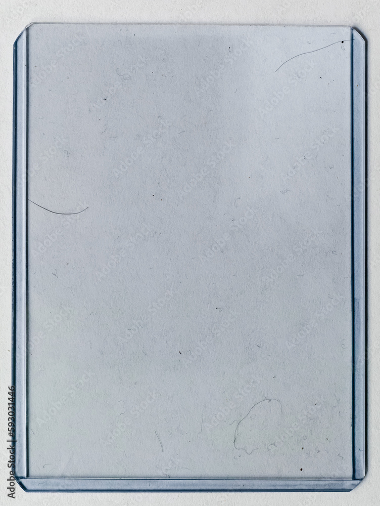 blank transparent plastic card toploader case on white paper background ...