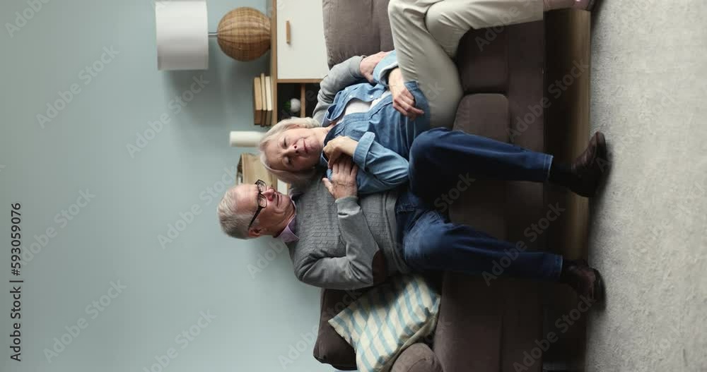 Calm older married couple in love relaxing on sofa at home, hugging ...