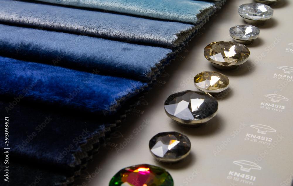 Upholstery fabric samples and diamond studded buttons. The designer ...