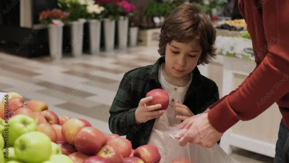father and his son working together to select freshest and tastiest ...