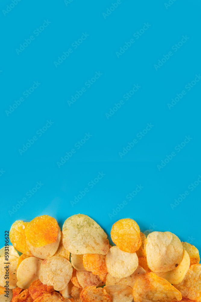 Border of potato chips isolated on vibrant blue background. Organic and ...