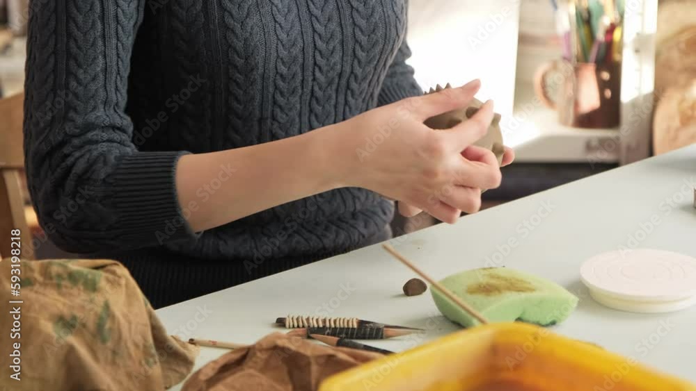 Process of creating pottery. Woman forming clay in pottery studio ...