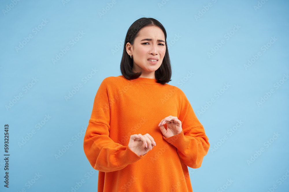 Disgusting. Asian korean girl cringes, grimaces from aversion and ...