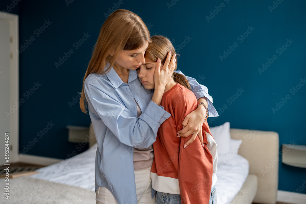 Fotka „Loving supportive mother hugging upset teen girl daughter, woman supporting mom child in ...