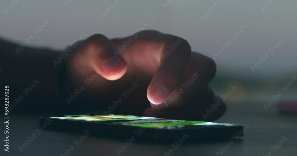 Finger of man touching scroll page app on mobile phone at night. Hands of person scrolling up ...