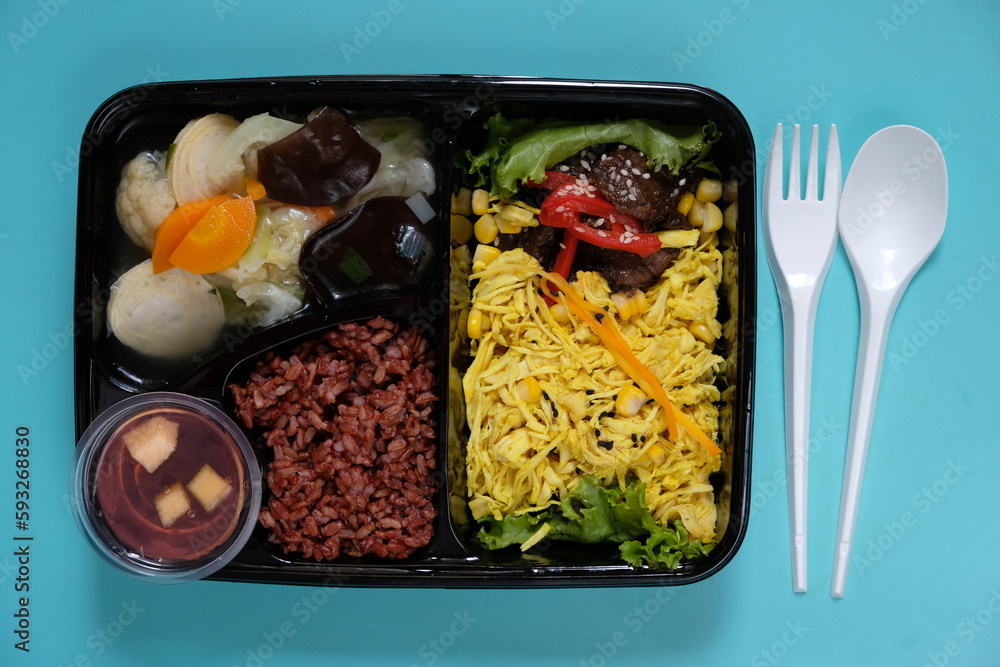 healthy food bento with brown rice, yellow shredded chicken, vegetable ...
