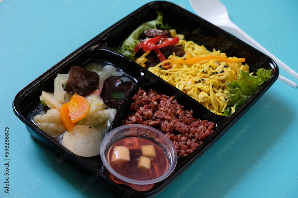 healthy food bento with brown rice, yellow shredded chicken, vegetable ...