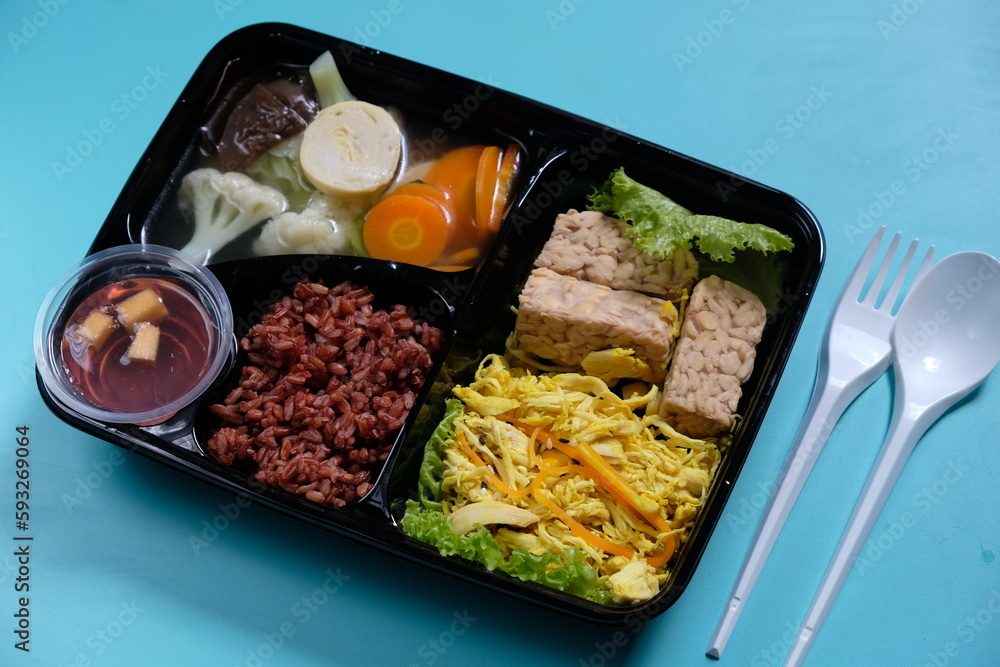 healthy food bento with brown rice, yellow shredded chicken, vegetable ...