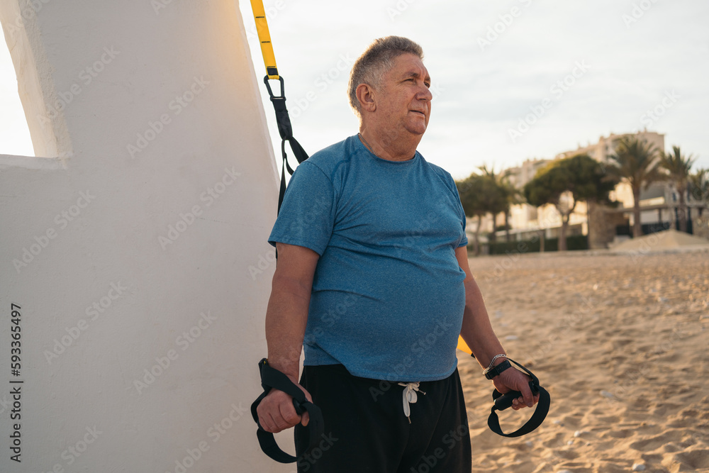 Older overweight white-haired person taking a break between exercises ...
