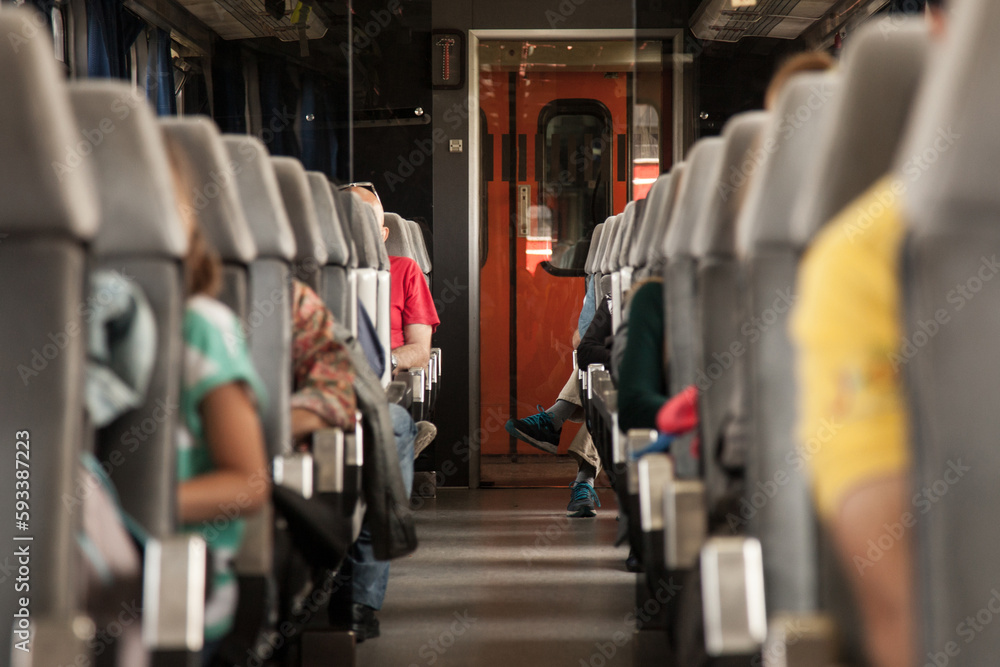 Seats of a passenger car in a European train with people seating on it ...