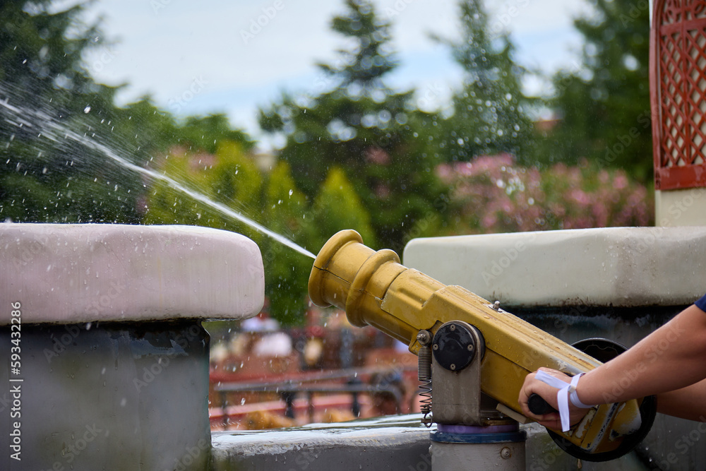 Long jet of warm water splashes from a water cannon at a summer ...