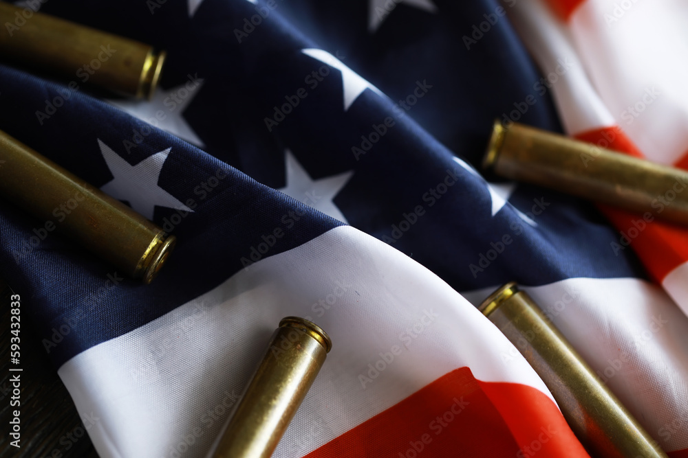 Many bullets cartridges and medals on United States flag. Concept of ...