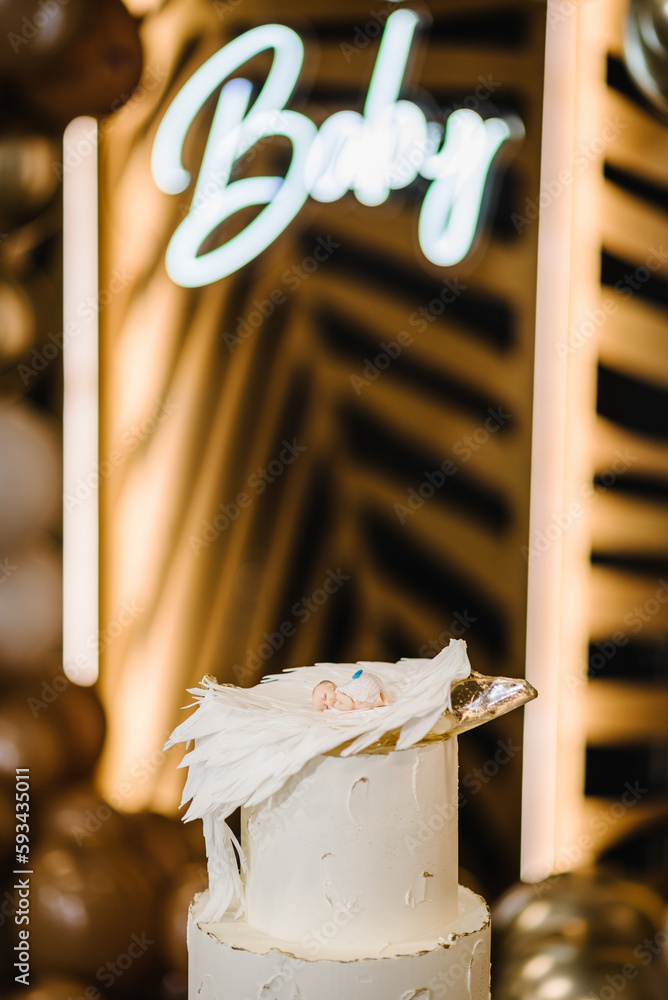 Details trendy cake with figure angel. Celebration baptism concept. Reception at birthday party ...