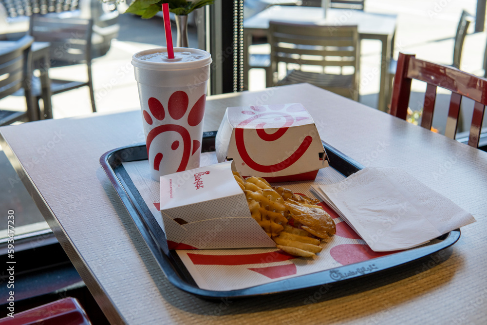 Chick-fil-a food on the table near the window in fast food restaurant ...