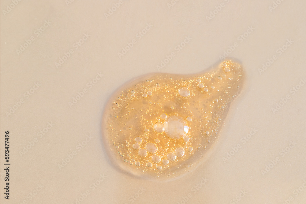 Jelly yellow trasparent liquid smear with bubbles on beige background ...