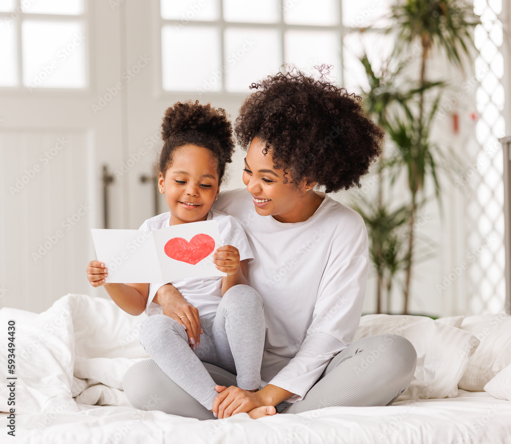 Cute little daughter giving his mom greeting postcard on Mother's day ...