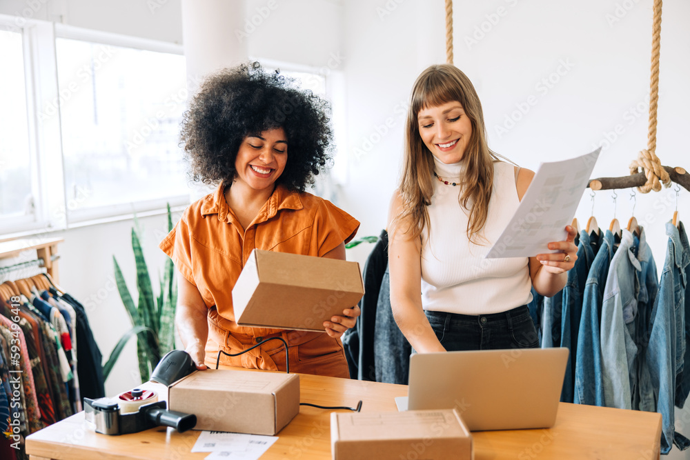 Happy clothing store owners preparing parcels for shipping Stock Photo ...