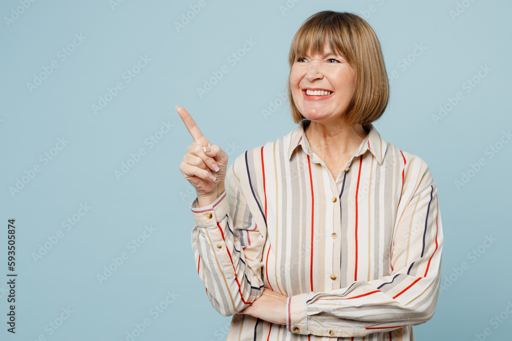 Elderly fun woman 50s years old wear light striped shirt pointing index ...