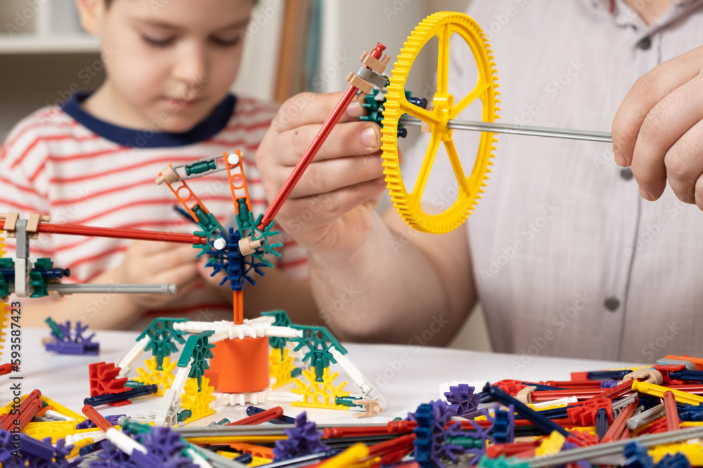 Dad and son build figures from the constructor. Spending time together ...