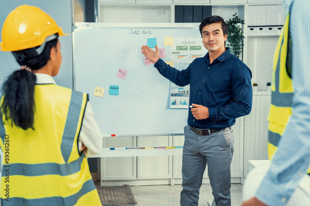 Entrepreneur brainstorming ideas with his competent engineers in the ...