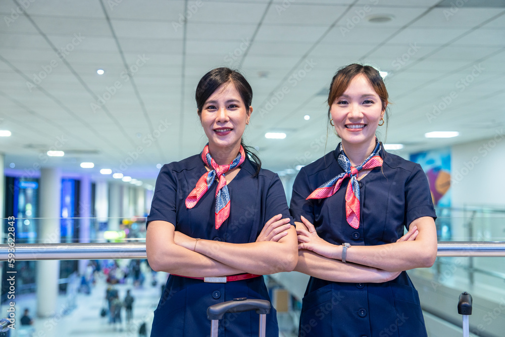 beautiful female asian two flight attendants wearing uniforms dragging ...