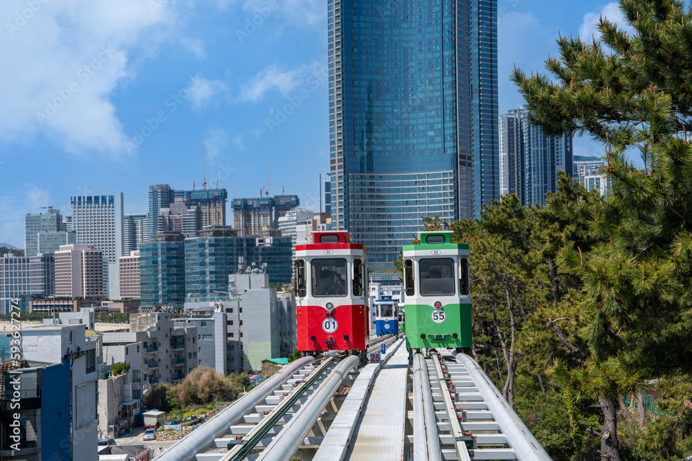 Sky capsule train running on seaside railway tracks in Busan, Korea. It ...