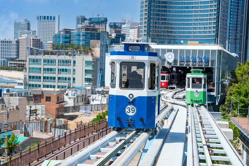 Sky capsule train running on seaside railway tracks in Busan, Korea. It ...