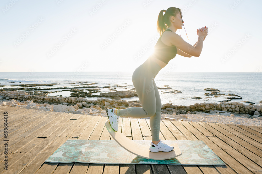 young girl trains balance using a balance board Stock Photo | Adobe Stock